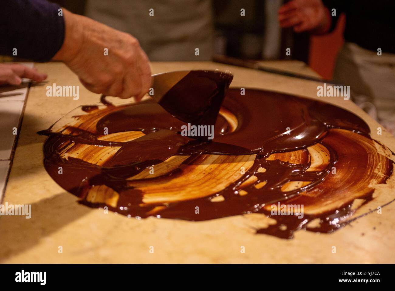 Chocolatier spreading chocolate as a demonstration Stock Photo - Alamy