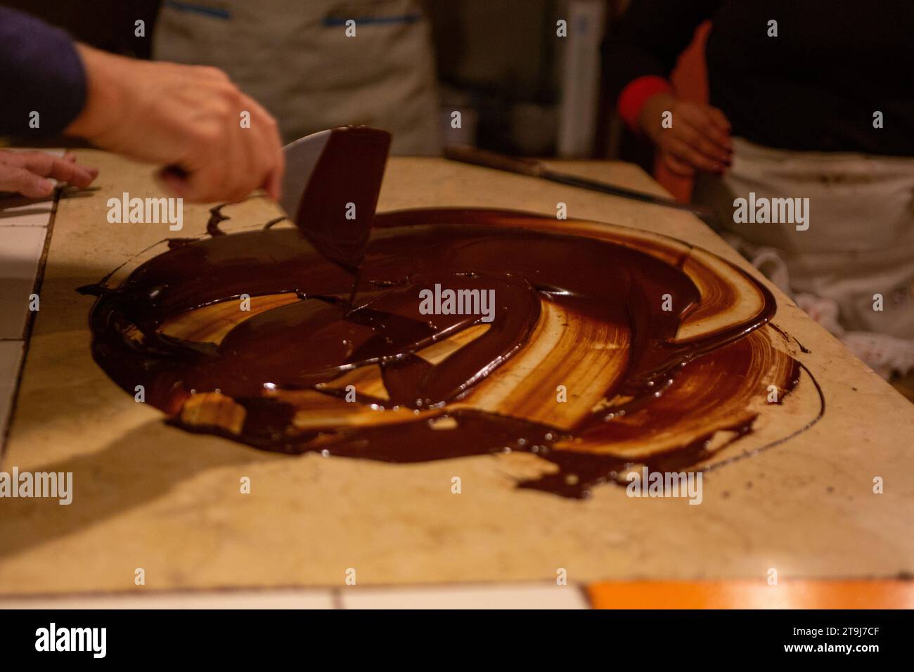 Chocolatier mixing melted liquid chocolate hi-res stock photography and ...