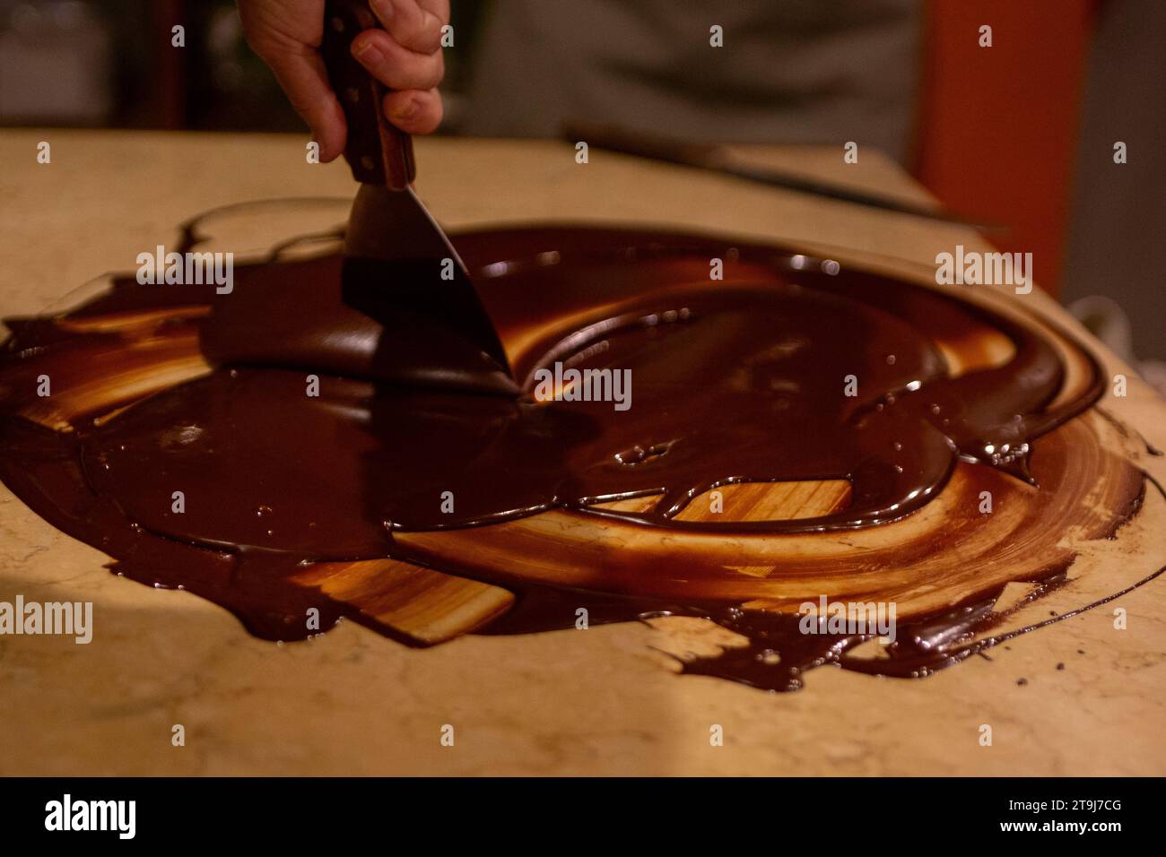 Chocolatier mixing melted liquid chocolate hi-res stock photography and ...