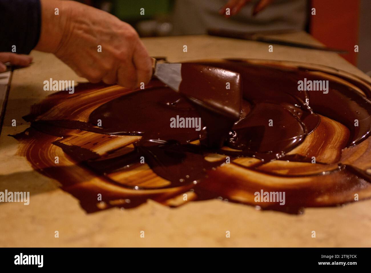 Chocolatier mixing melted liquid chocolate hi-res stock photography and ...