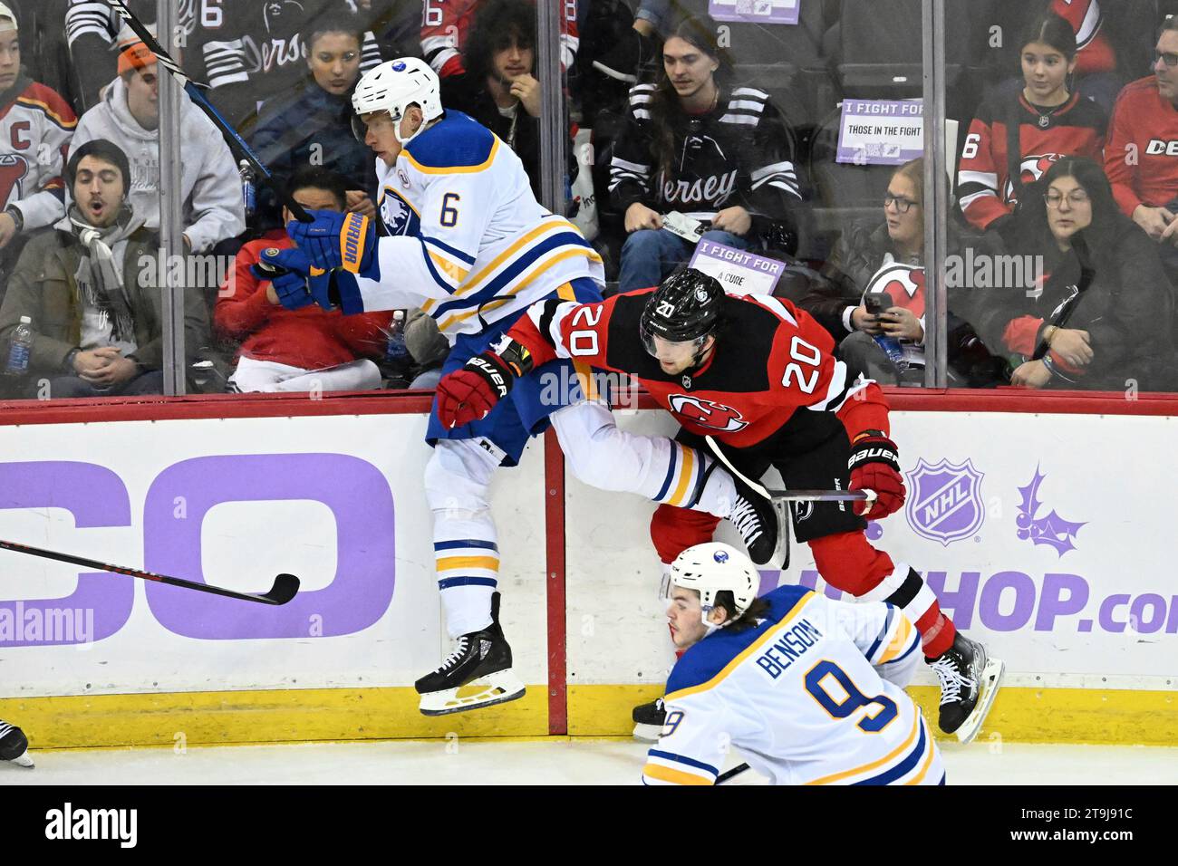 New Jersey Devils center Michael McLeod (20) checks Buffalo Sabres ...