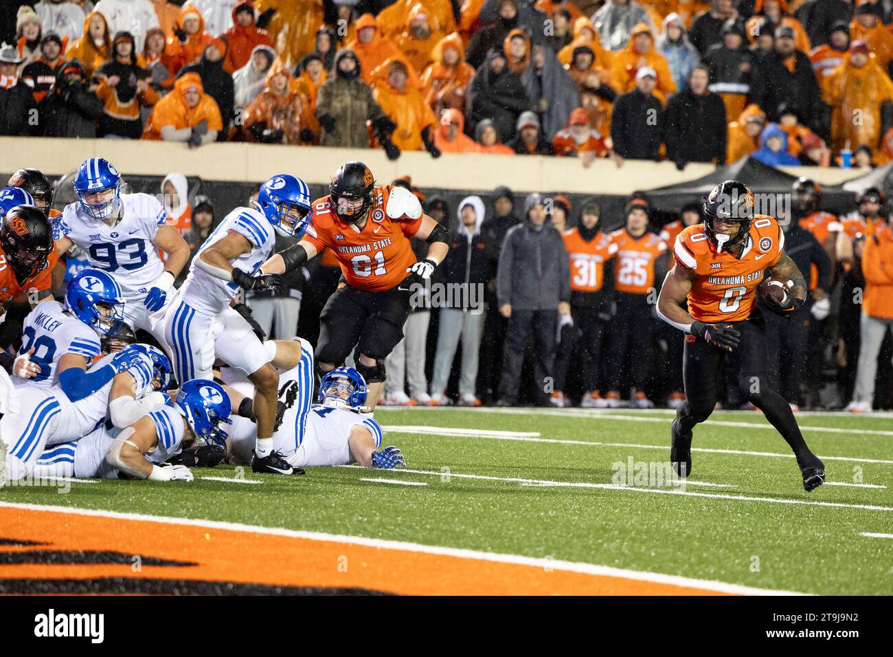 Oklahoma State running back Ollie Gordon II (0) runs past BYU defenders ...