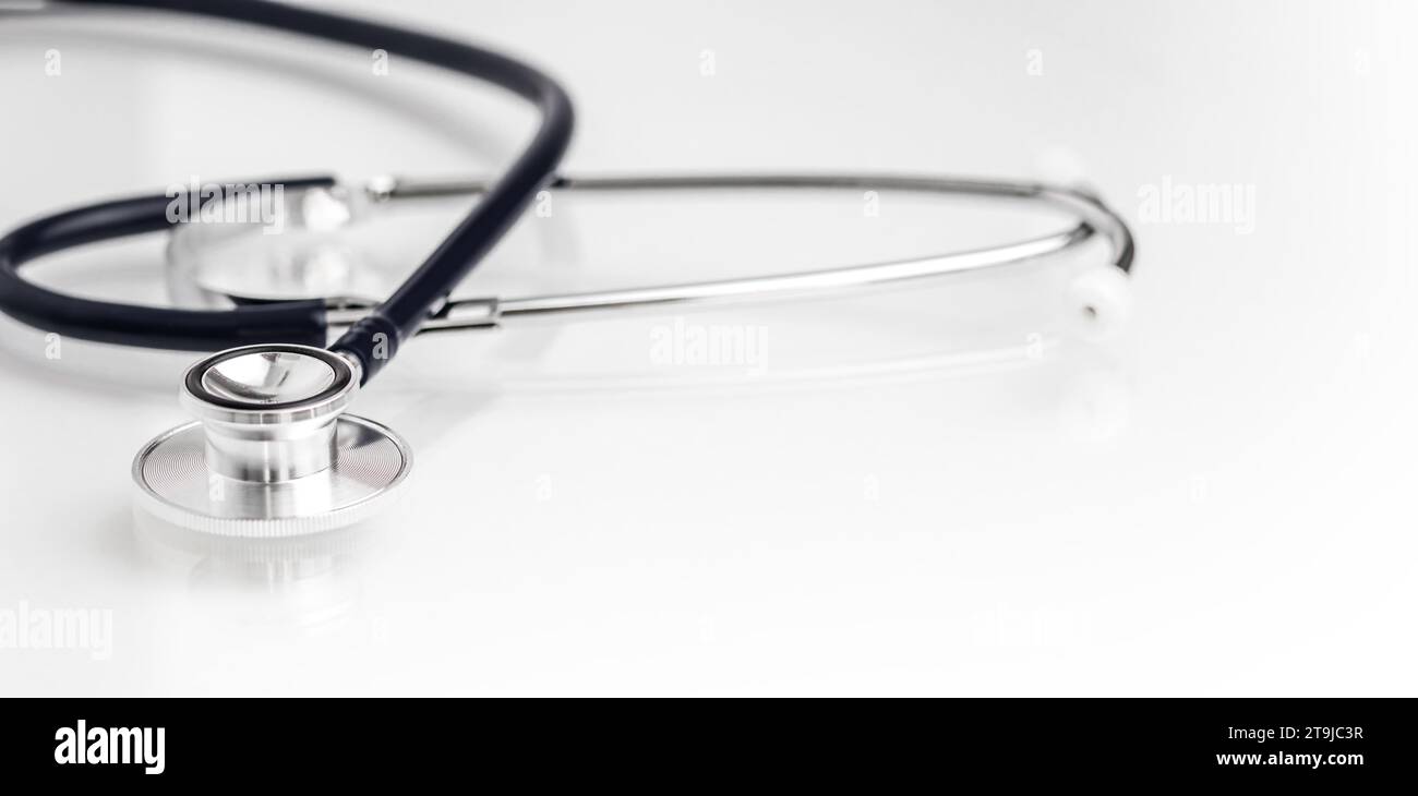 Stethoscope on white glass table with copy space. Healthcare and ...