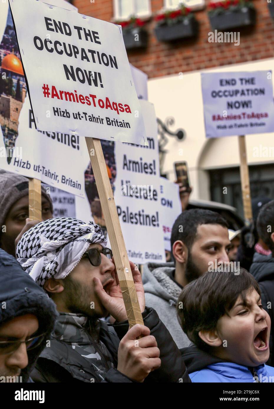 London, UK. 25th Nov, 2023. Protesters join together in chanting while ...