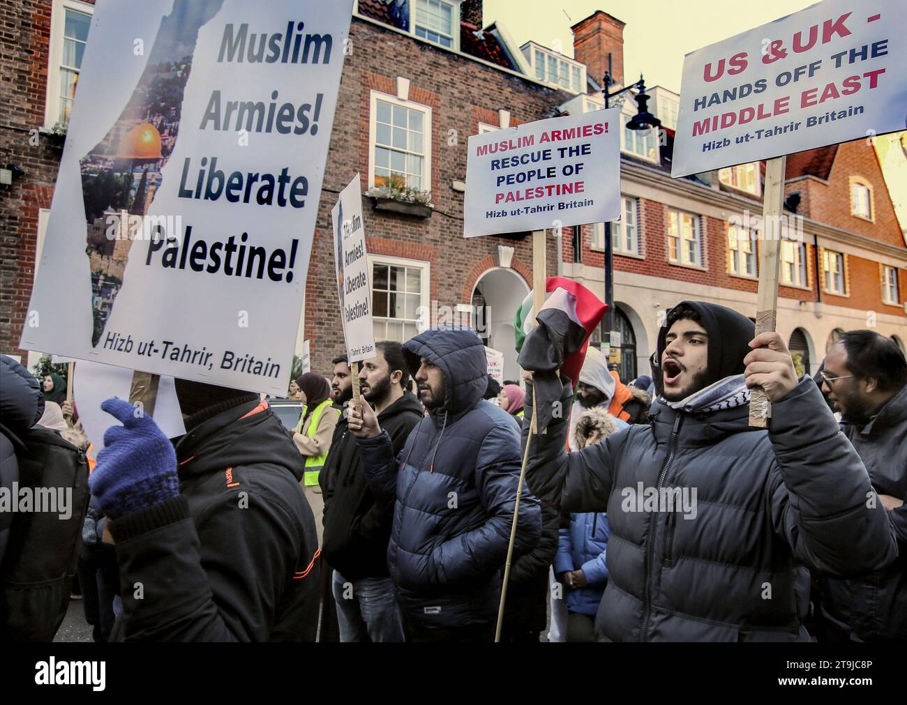 Supporters chant with speakers holding placards calling for Muslim ...