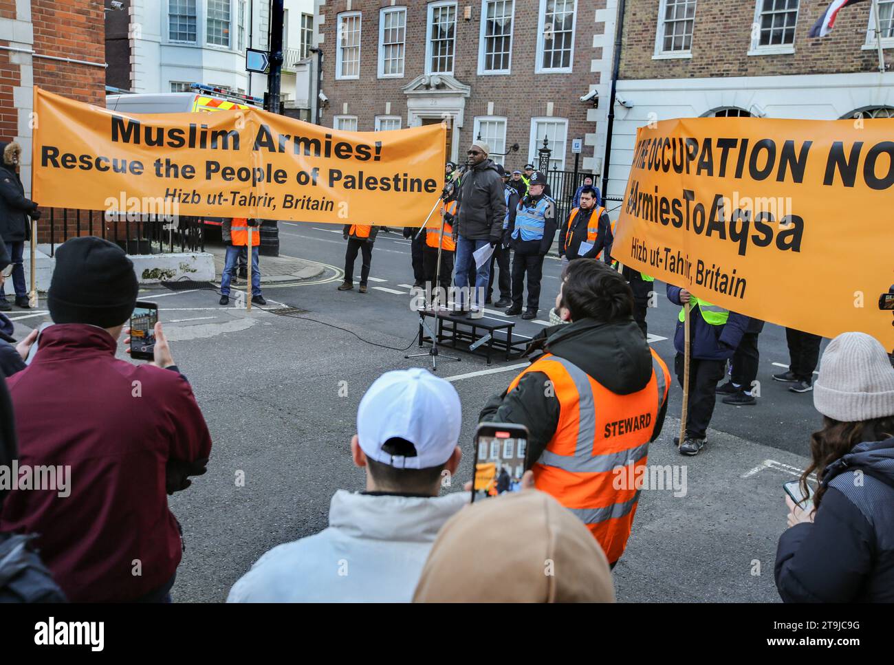 London, UK. 25th Nov, 2023. Protesters hold large banners at the front ...