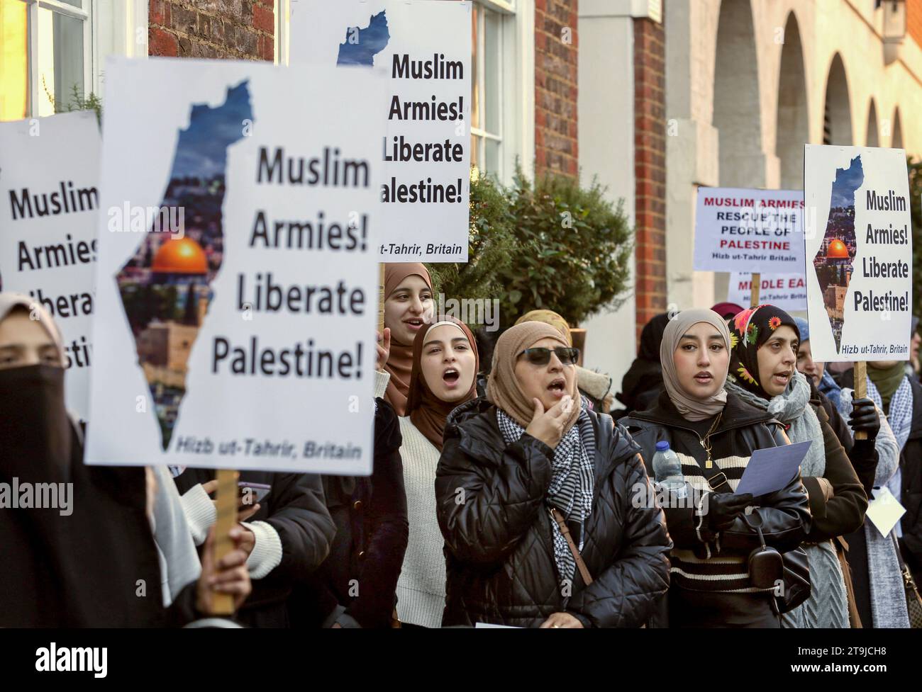 Women supporters stand and chant in response to speakers, holding ...