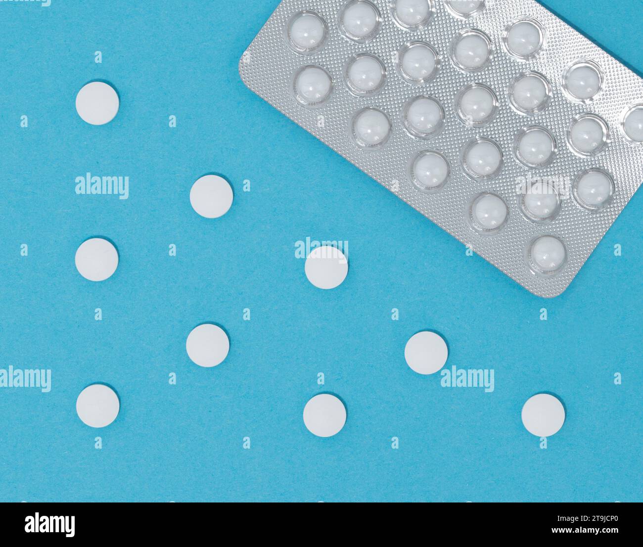 White pills, silver antibiotic on blue background, top view. Pharmacy ...