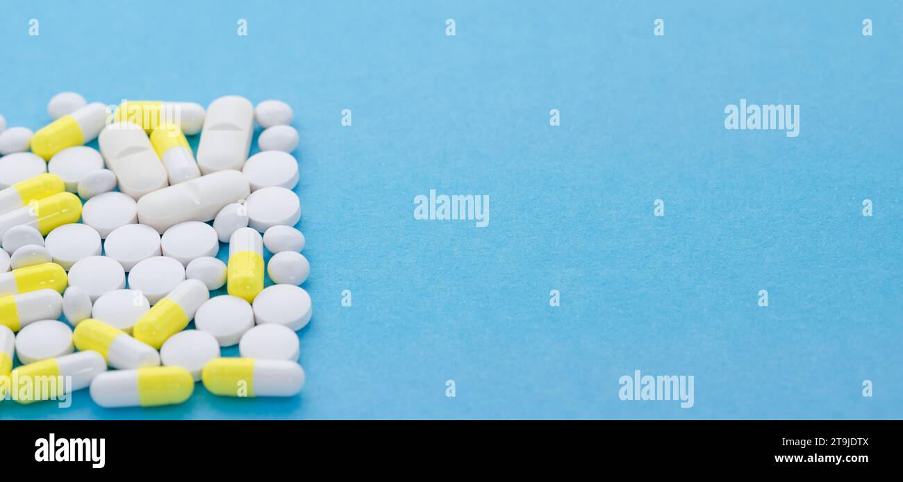 Drug prescription for treatment medication. Heap of yellow white round ...