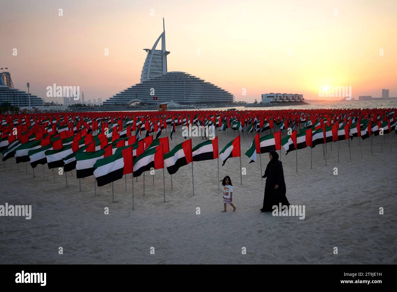 FILE - An Emirati mother walks with her daughter in front of six ...