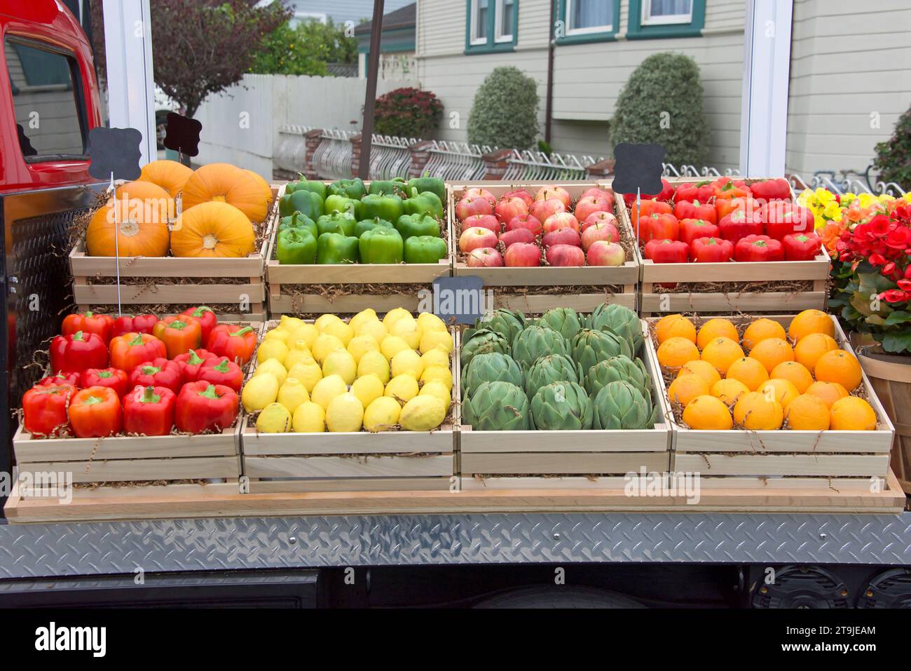 Fresh produce, fruits and vegetables, in display crates on the back of ...