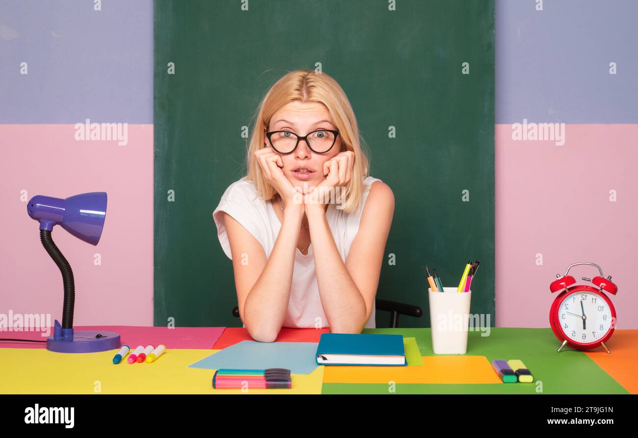 Female teacher in the classroom on the chalkboard. College girl in ...