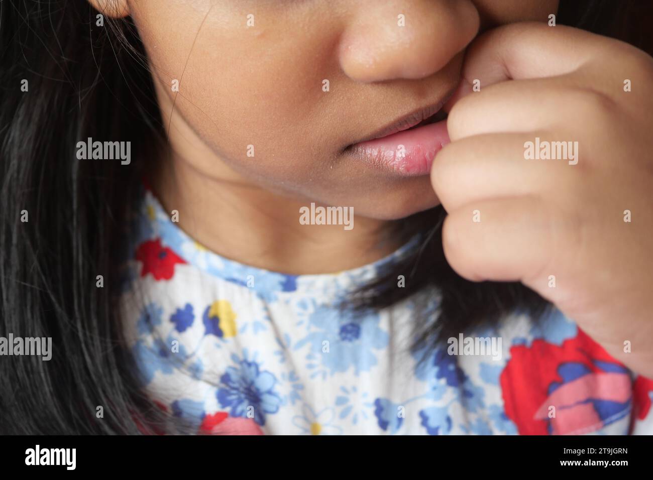 child girl biting her nails at home Stock Photo - Alamy