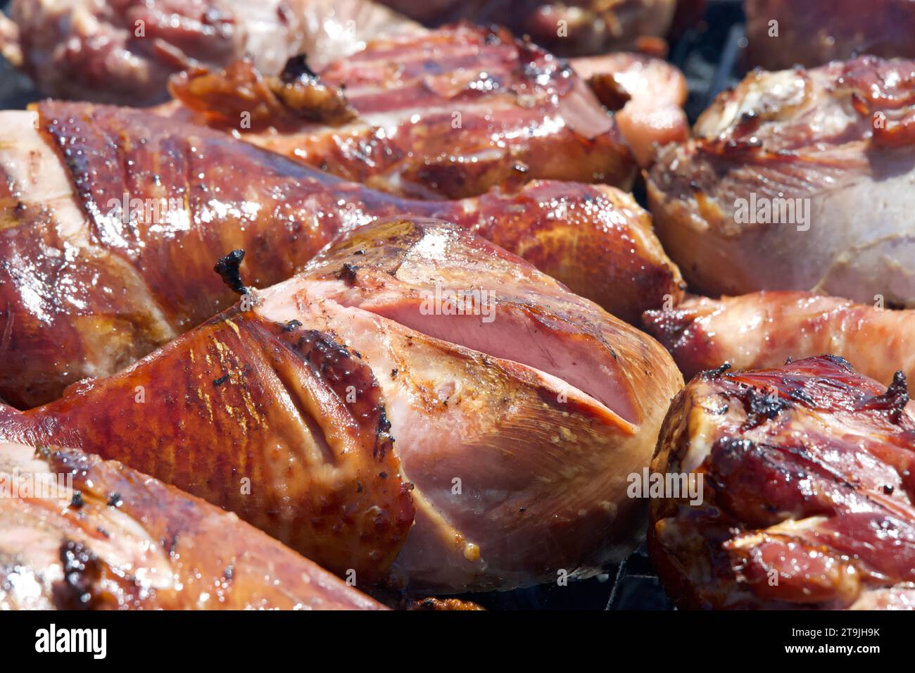 Turkey legs grilling on a BBQ grill. Giant turkey legs are a very ...