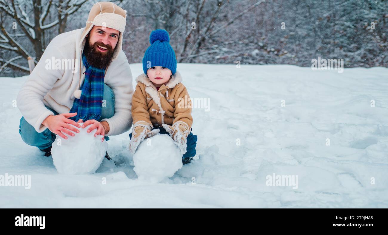 Cute little child boy and happy father on snowy field outdoor. Father ...