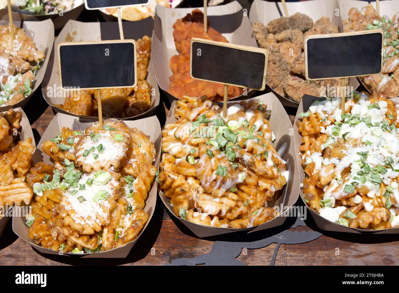 Close up on containers of fast food on brown table with blank label ...