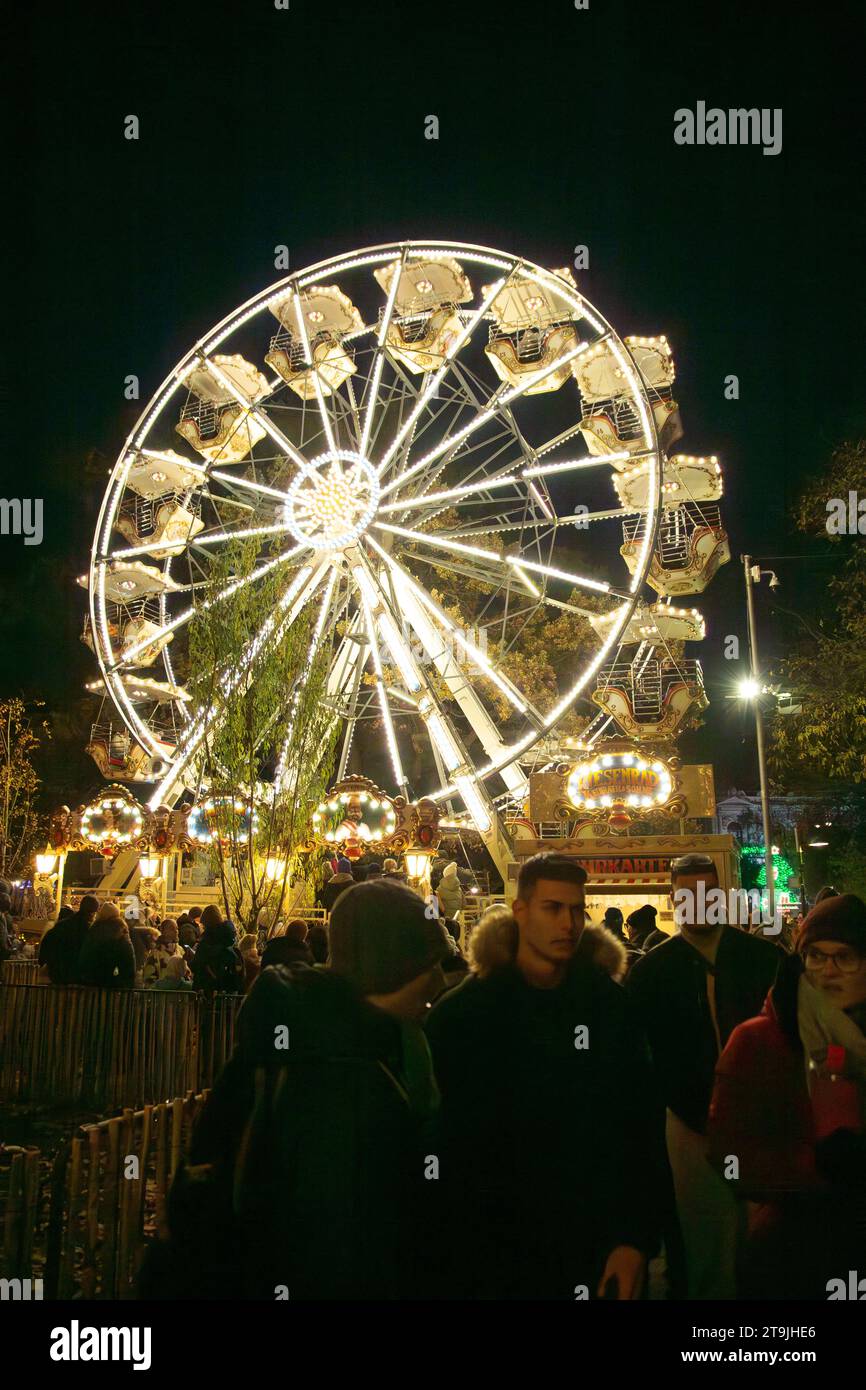 The golden ferris wheel in the middle of the busy Christmas Market ...