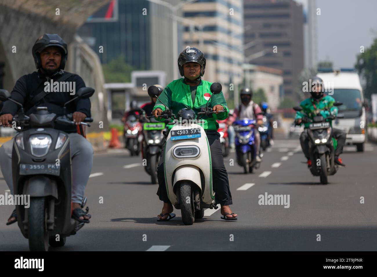 Jakarta, Indonesia - November 26, 2023: People commuting through the streets of Jakarta ...