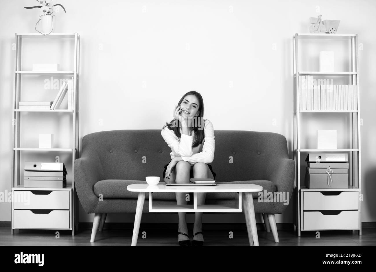 Young smiling businesslady at workplace in the office. Secretary woman ...