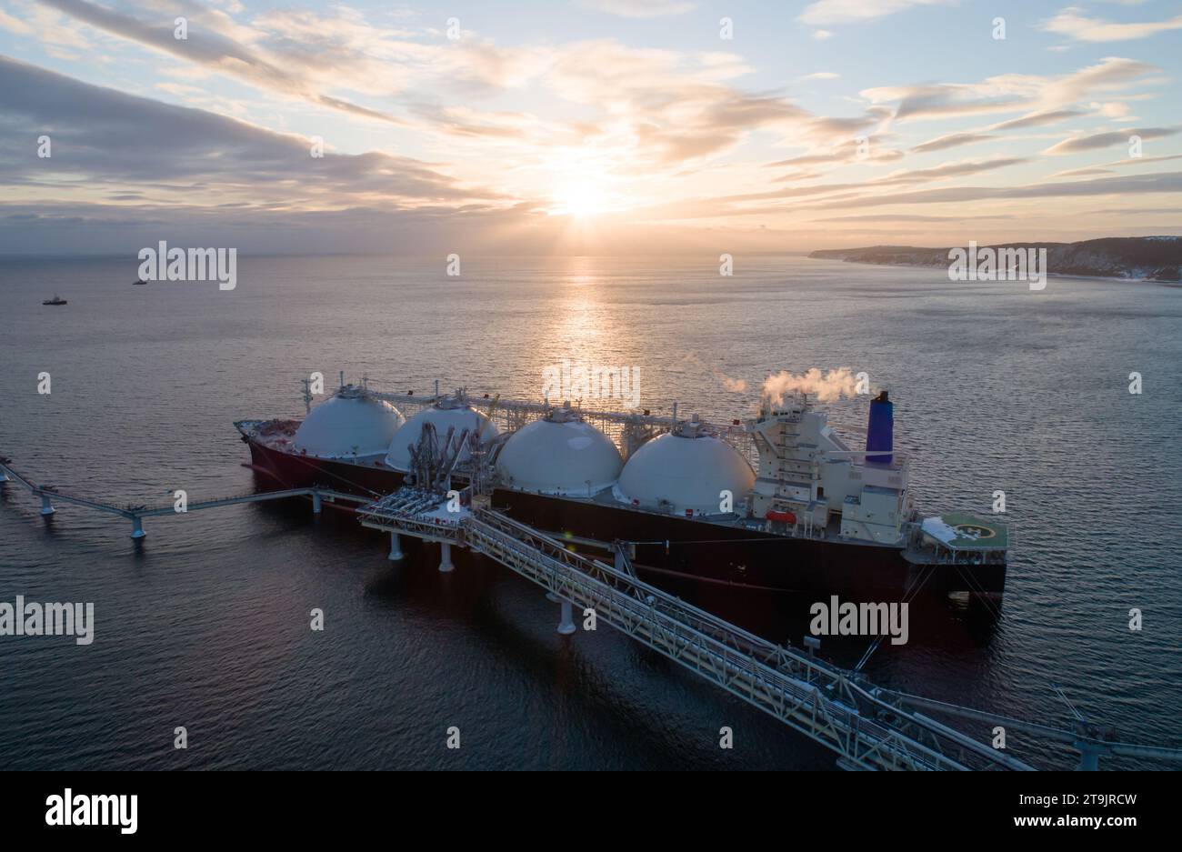 Aerial of Liquified Natural Gas LNG carrier moored to a small gas ...
