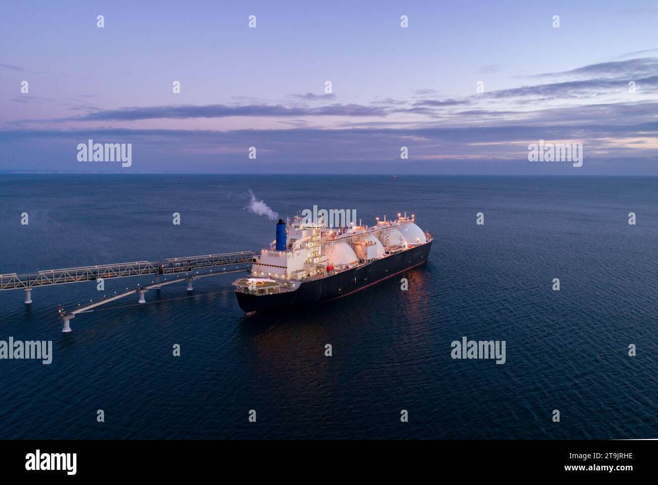 Aerial of Liquified Natural Gas LNG carrier moored to a small gas ...