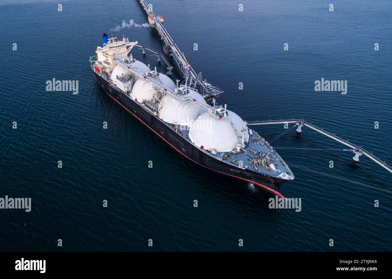 Aerial of Liquified Natural Gas LNG carrier moored to a small gas ...