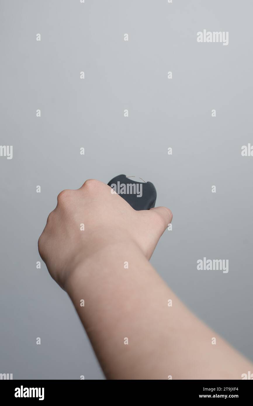 Hand holding shock stun gun on gray background. Electric shocker for ...