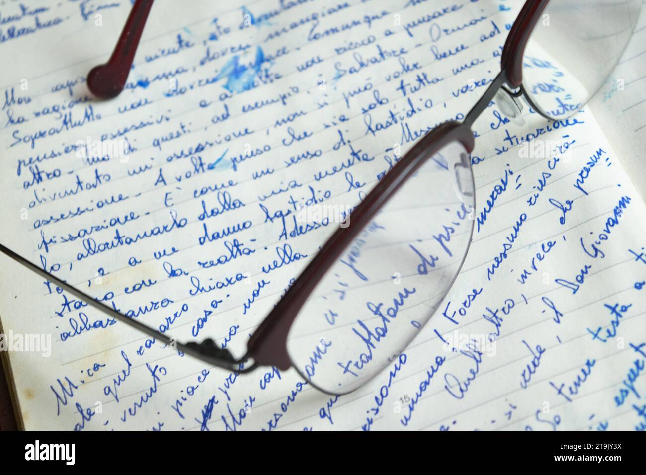handwritten sheet with the writing seen through a pair of glasses Stock ...