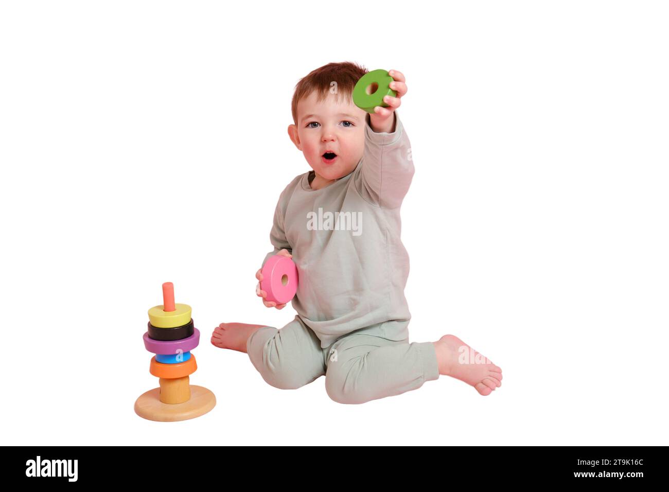 Happy toddler baby plays with a pyramid on a studio, isolated on white ...