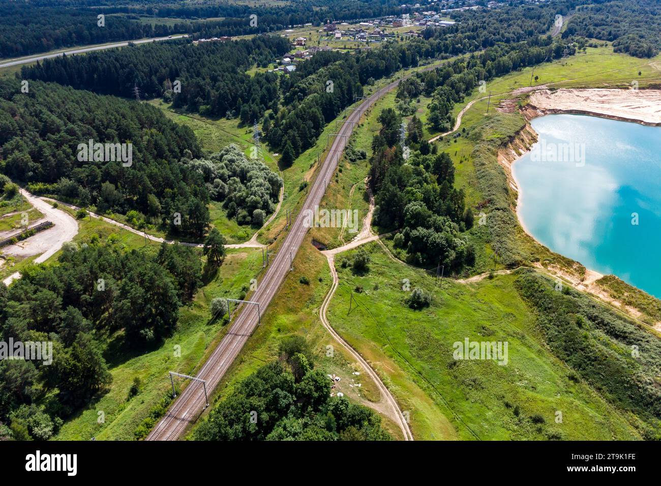 A railway line passing next to a flooded quarry, aerial view Stock ...
