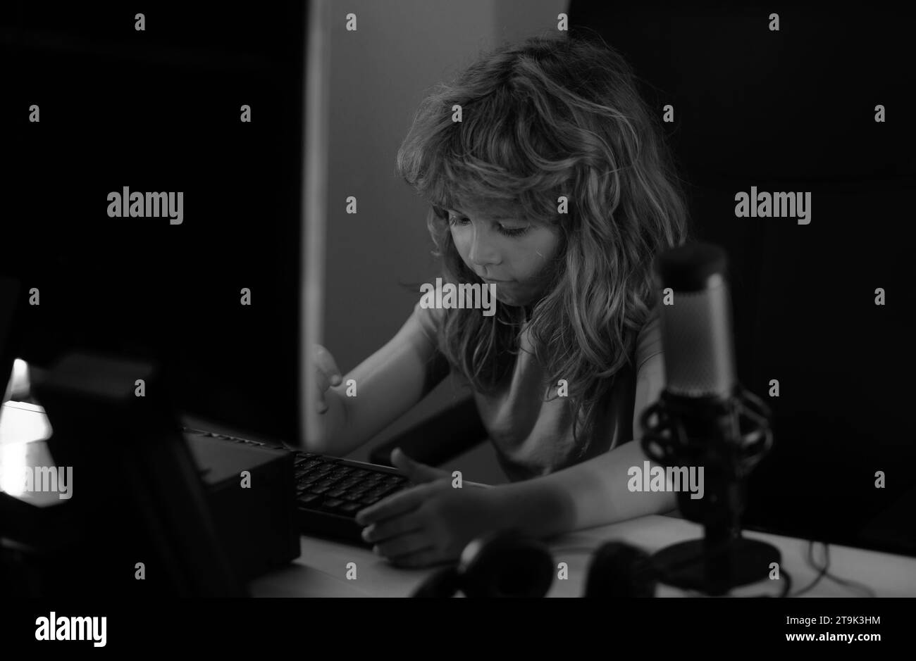 Little child gamer play computer game on desktop. Gaming stream and ...