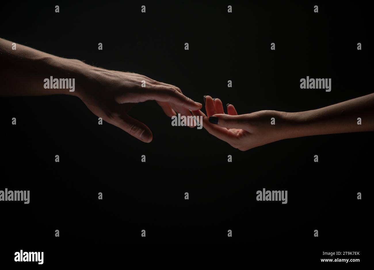 Romantic touch with fingers, love. Two hands stretch each other, black ...