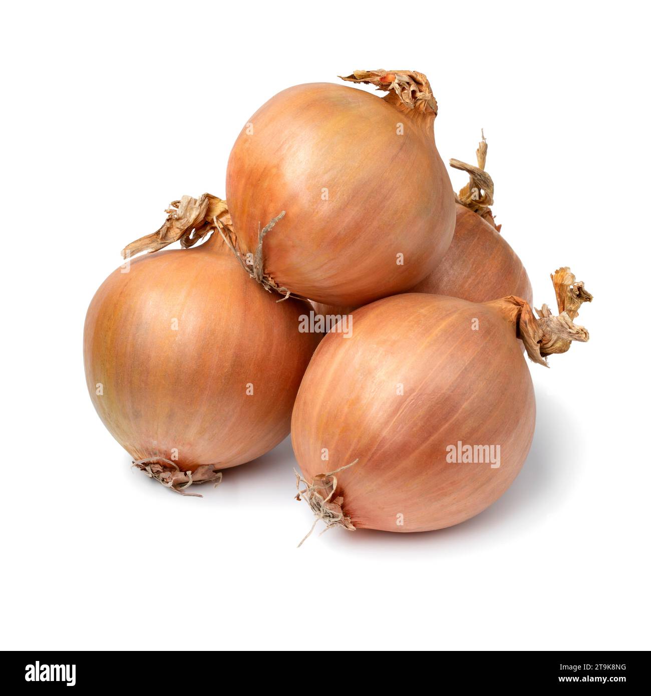 Heap with fresh raw brown onions isolated on white background close up ...