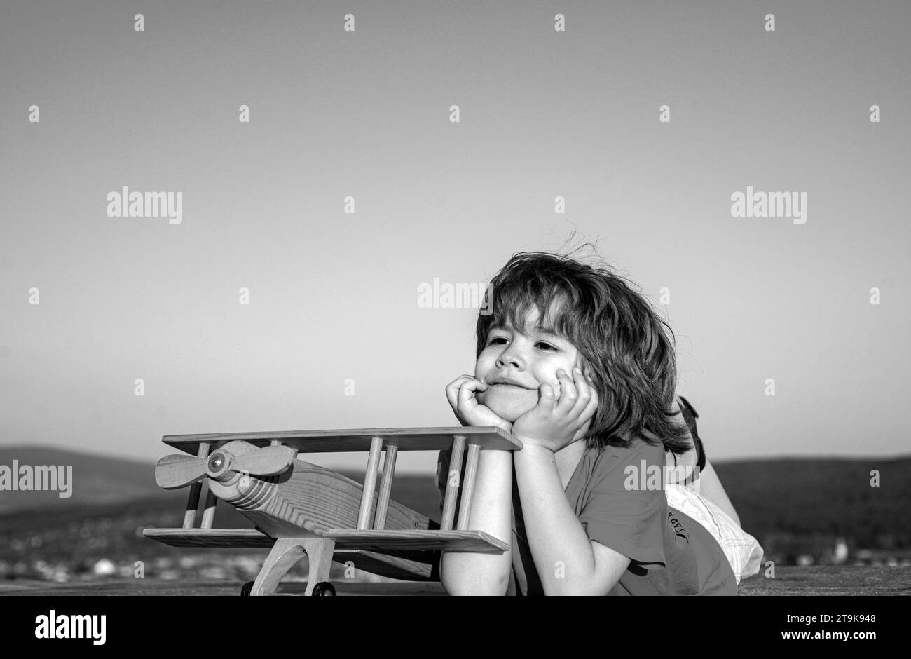 Child boy playing with wooden toy airplane, dream of becoming a pilot ...