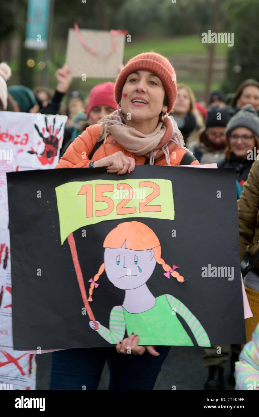 Rome, Italy. 25th Nov, 2023. A woman shows a sign with the number 1522 ...