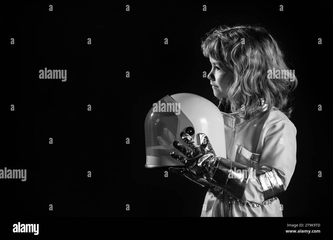 Cute little boy spaceman child in space suit holding helmet. Success ...