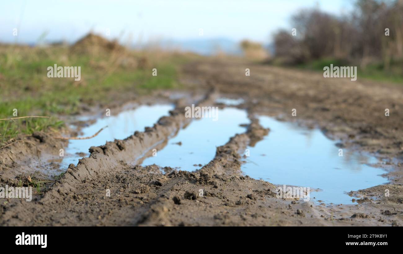 Muddy earthy road shooting from ground level. Countryside landscape ...