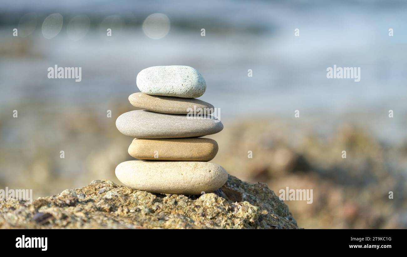Stone cairn pyramid at seaside. Stack of balanced stones on the beach ...