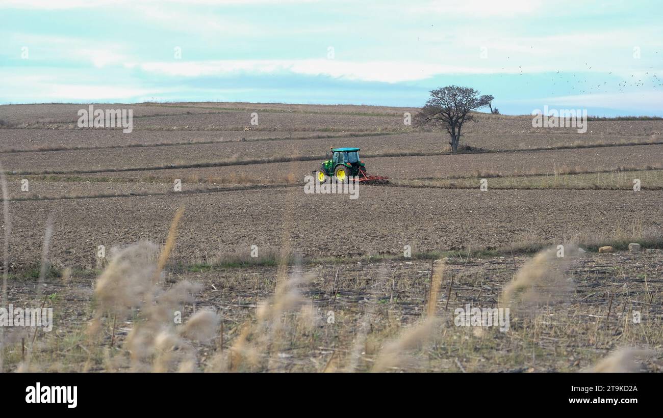 Agriculture tractor cultivating seeding plough field farm land. Open ...