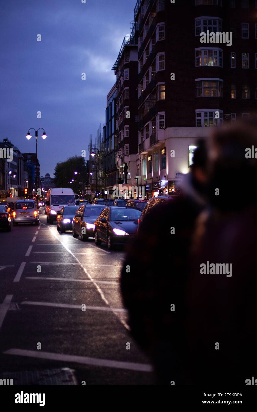 Knightsbridge with persons shadow obscuring busy road full of traffic ...