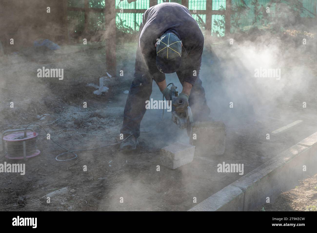 A man cuts a stone with an angle grinder Stock Photo - Alamy