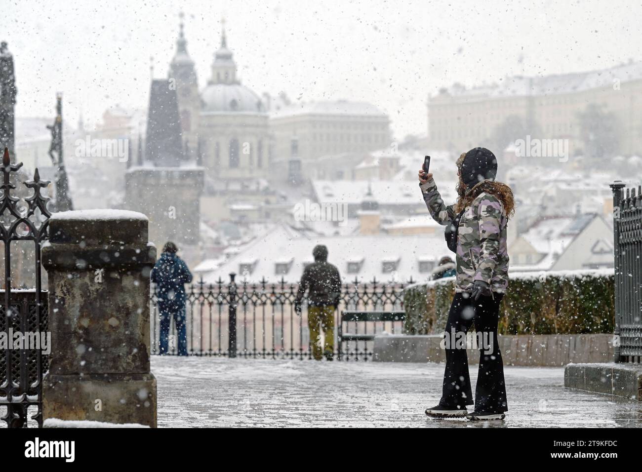 Prague, Czech Republic. 26th Nov, 2023. A tourist takes a photo near ...