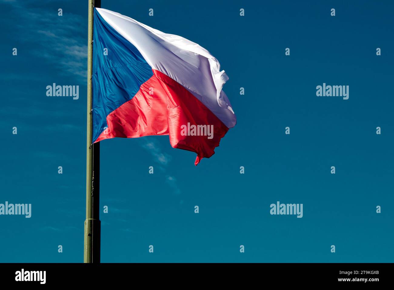 A photo of the Czech Republic flag flying on a flagpole against a blue ...