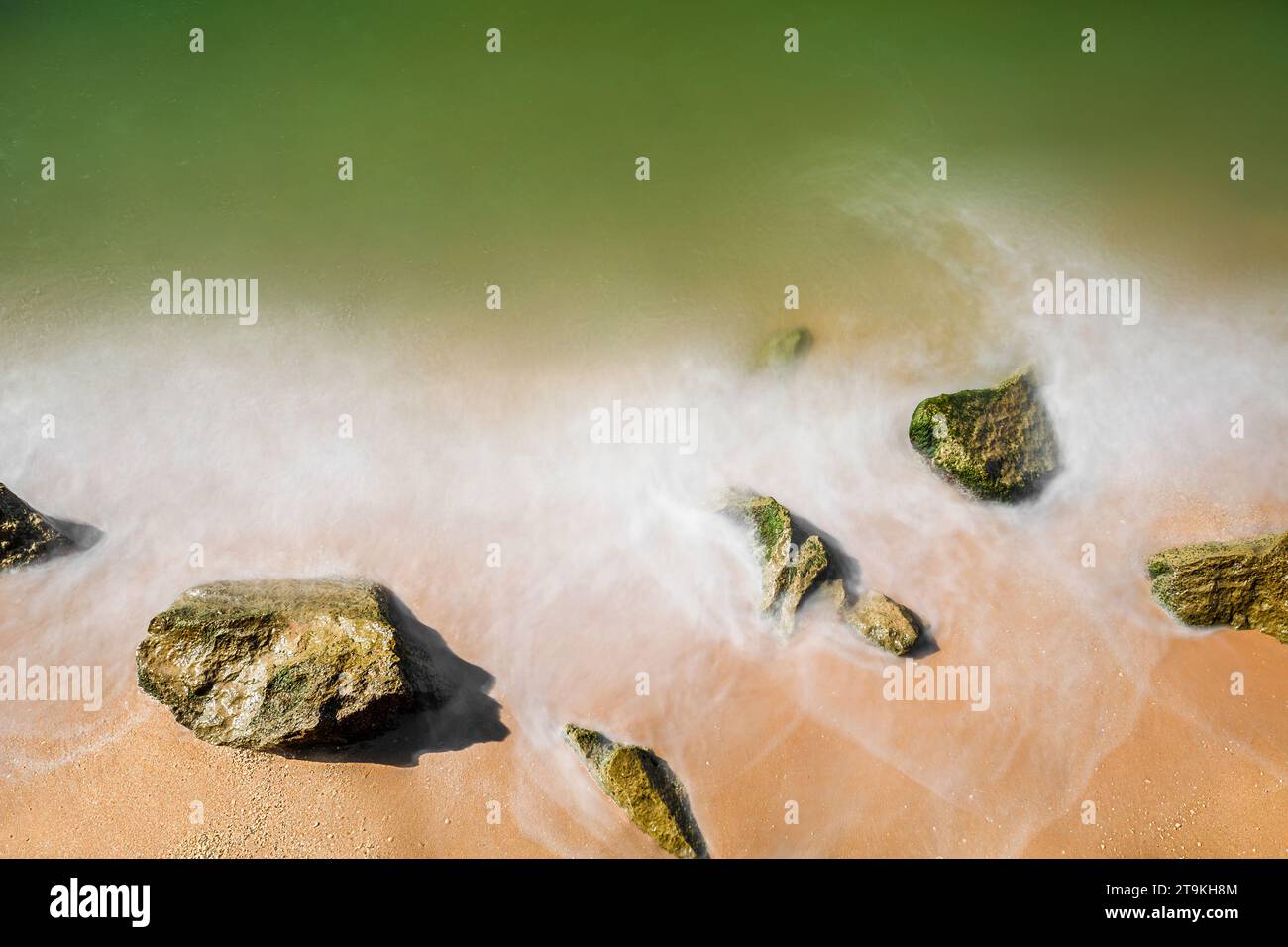 Sea sandy beach with stones, blurry water movement Stock Photo - Alamy