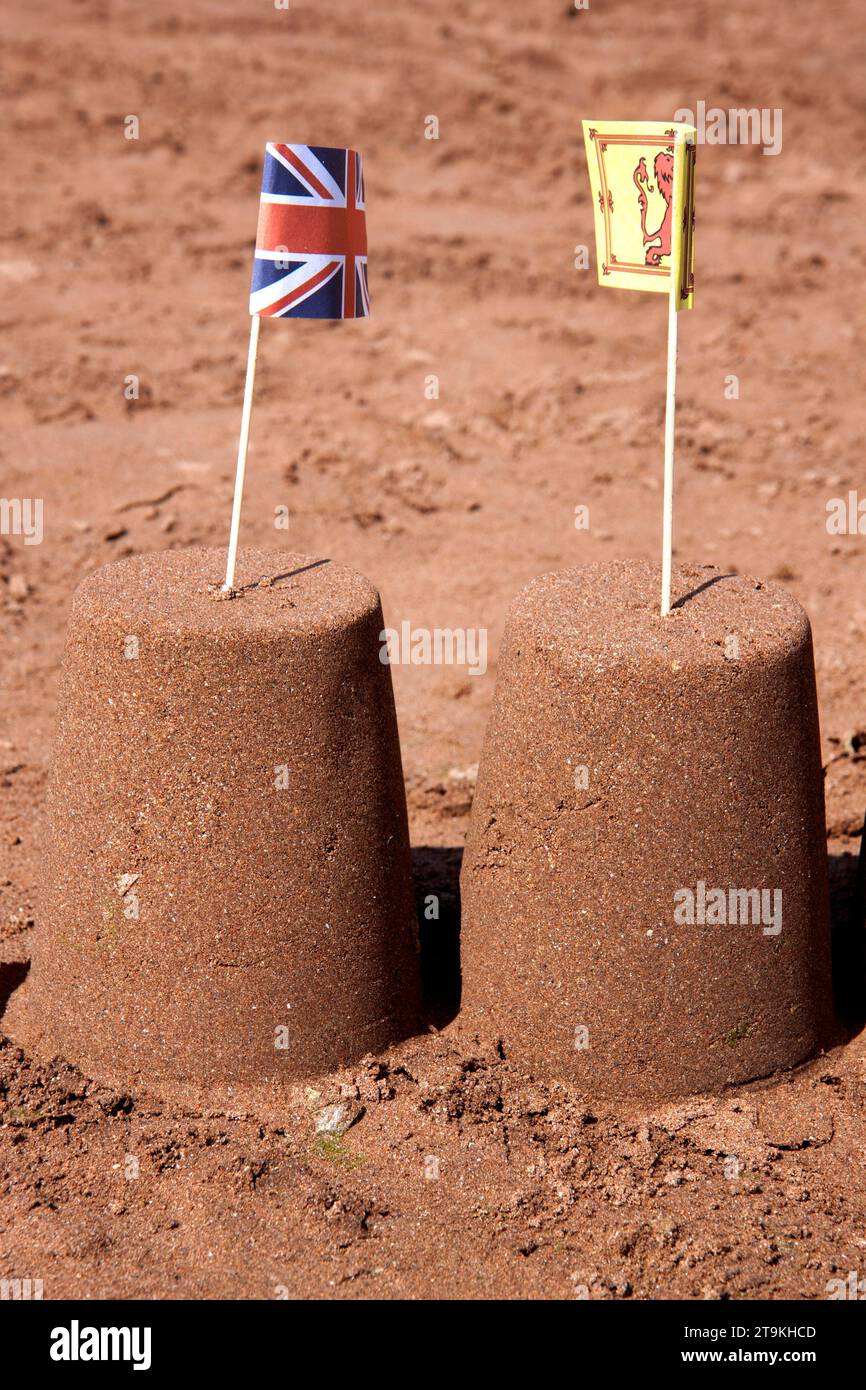 Two sand castles on the beach during summer with a British and Welsh ...