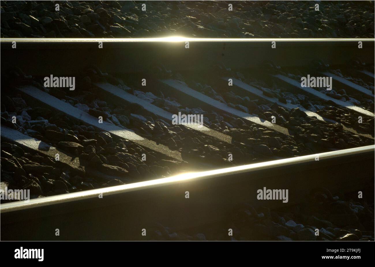 Railroad track with sun reflex Stock Photo - Alamy