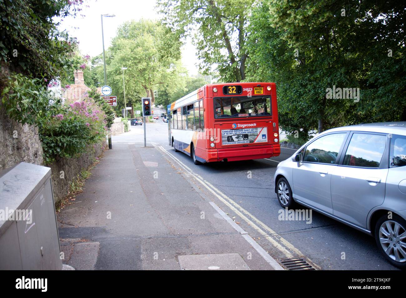 back of number 32 local red bus at traffic lights in Torquay Devon U.K ...