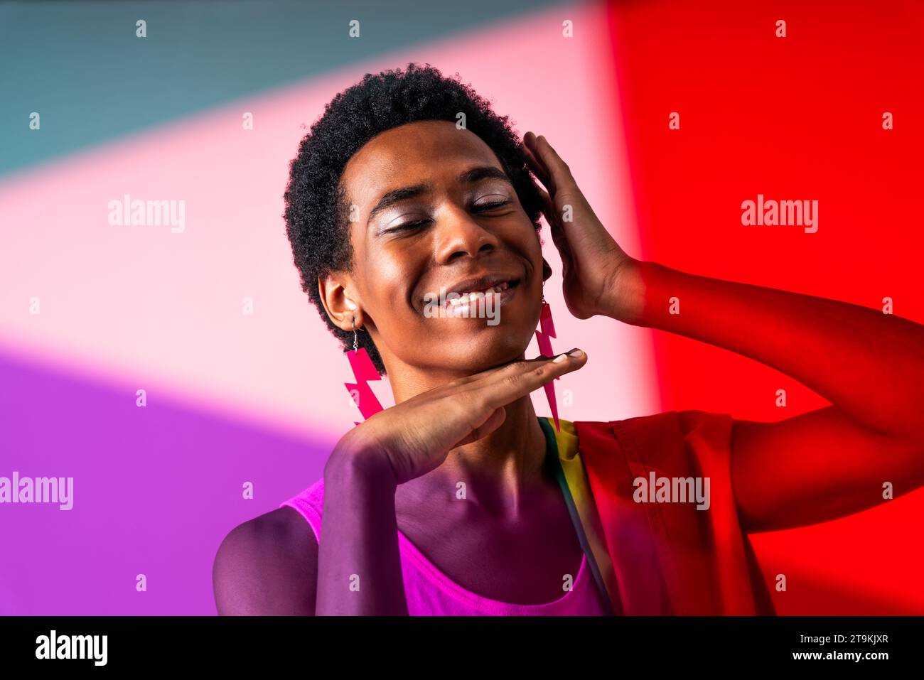 Fluid gender hispanic latin black man posing in studio with fashionable ...