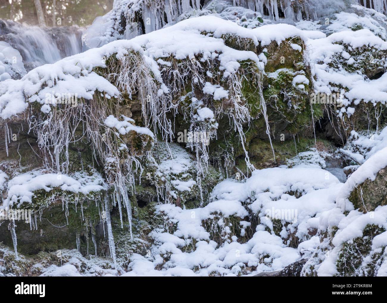 frozen fast flowing spring water, icy rocks and water stream, frosty ...