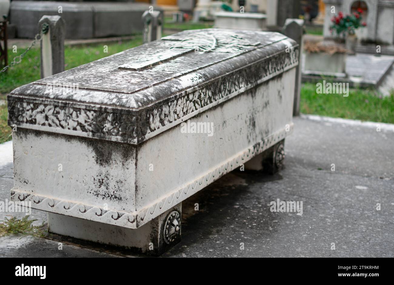 Ancient Coffin Carved in Stone with blurred background of cemetery and ...